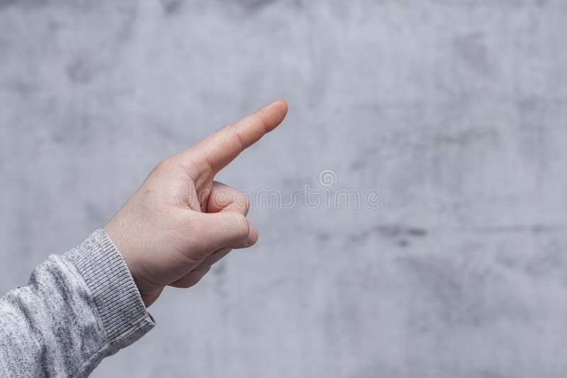 Concept of Pointing Finger. Close-up of a Man in a Sweater Pointing His ...