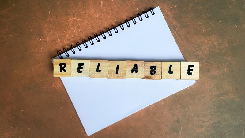 Concept of Reliable Writing on Wooden Cube Isolated on Work Desk Stock ...