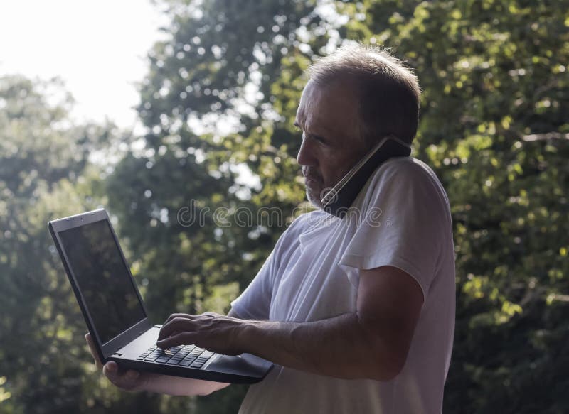 The Concept of Remote Work in Nature,a Person Conducts Negotiations on ...
