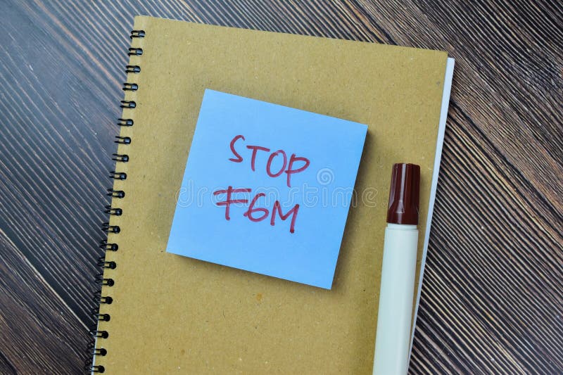 Concept Of Stop Fgm Write On Sticky Notes Isolated On Wooden Table