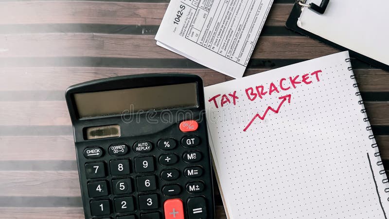 Concept of Tax Bracket Write on Book Isolated on Wooden Table Stock ...
