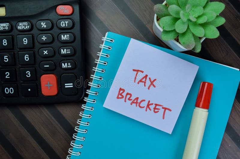 Concept of Tax Bracket Write on Sticky Notes Isolated on Wooden Table ...