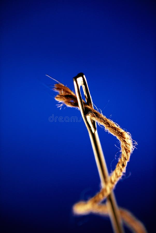Thread and Needle Against Blue Background Stock Image - Image of needle ...