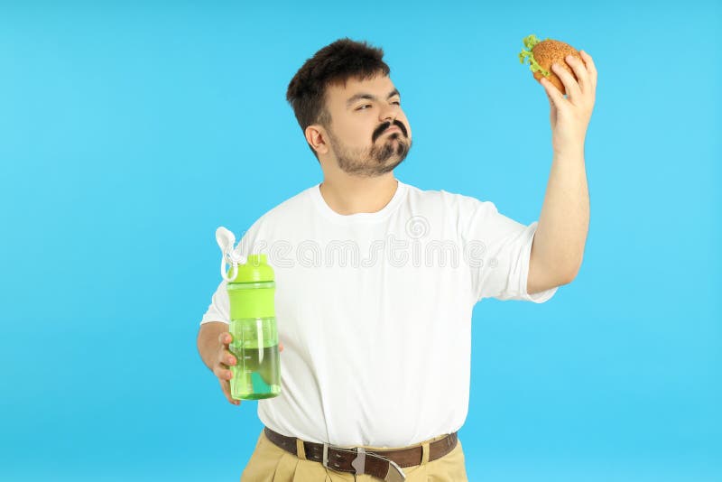 Concept of Weight Problems, Young Fat Man on Blue Background Stock ...