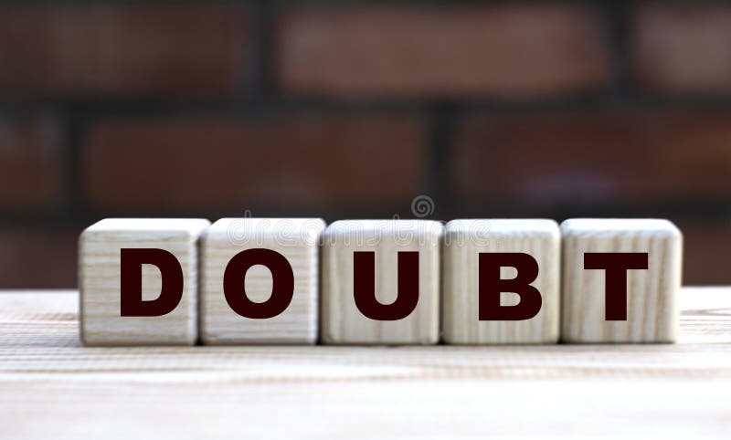 Concept Word DOUBT on Cubes Against the Background of a Brick Wall ...