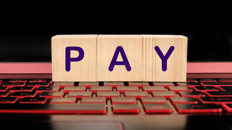 Concept Words PAY on Wooden Blocks on the Keyboard. Business Concept ...