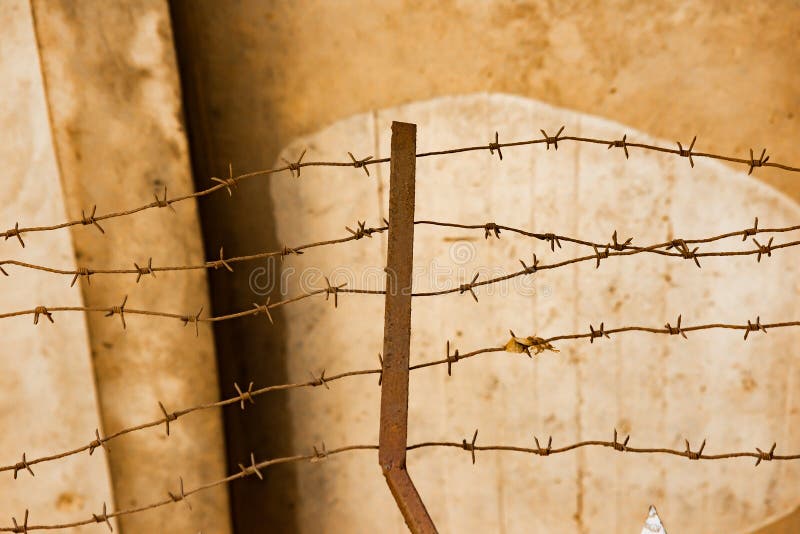 Yellow Dilapidated Wall and Barbed Wire Stock Photo - Image of punish ...
