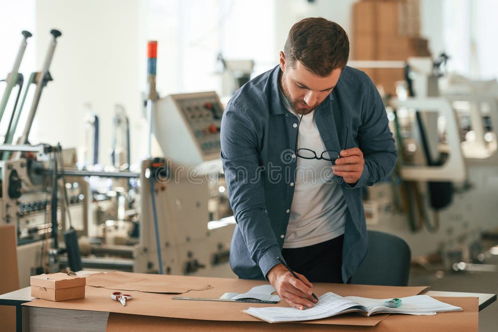 Conception of Labor. Handsome Man is Working at the Factory of Creating ...