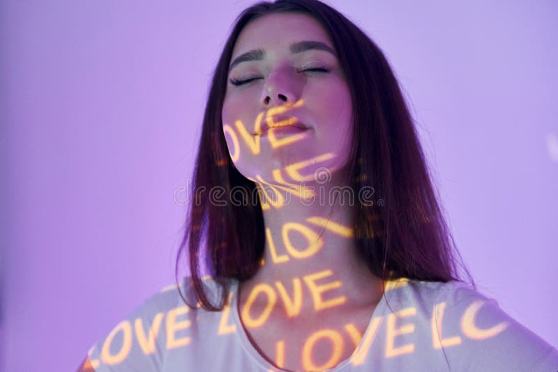 Conception of Love. Beautiful Young Woman is in Projector Neon Lights ...