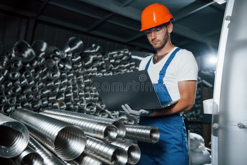 Conception of Manufacturing. Man in Uniform Works on the Production ...