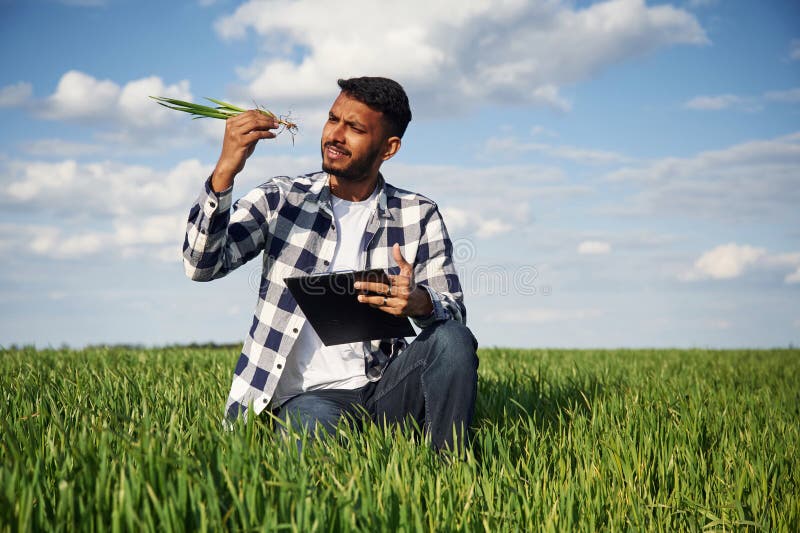 Standing and Holding Notepad. Handsome Indian Man is on the ...