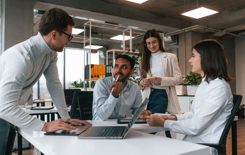 Conception of Teamwork. Four People are in the Office Together Stock ...