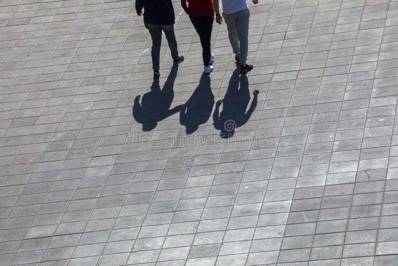 Conceptual Photography Shadow of Three Guys on a Pavement, Top View ...