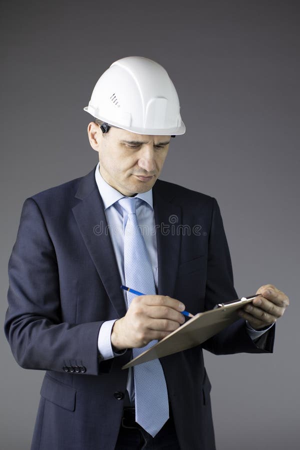 Concerned Constructor in White Helmet and Formal Clothing Writes on ...