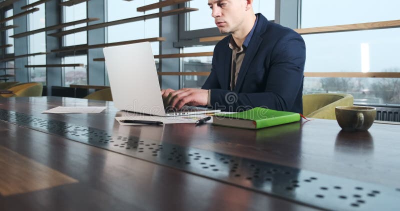 Concerned Man Working on Laptop Computer and Looking Away Thinking ...