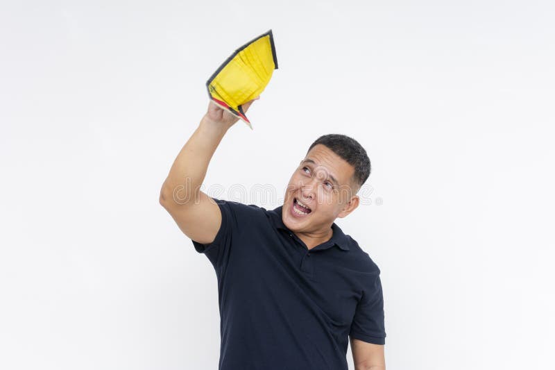 Concerned Middle Aged Asian Man Looking into His Yellow Empty Wallet ...