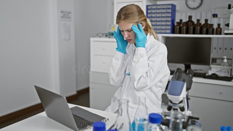 A Concerned Woman Scientist in Lab Coat Feeling Stressed in a ...
