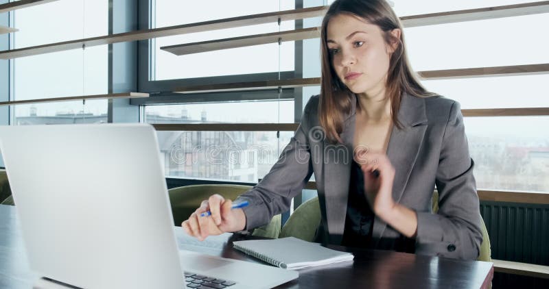 Concerned Woman Working on Laptop Computer and Looking Away Thinking ...
