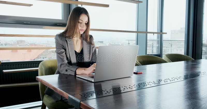 Concerned Woman Working on Laptop Computer and Looking Away Thinking ...