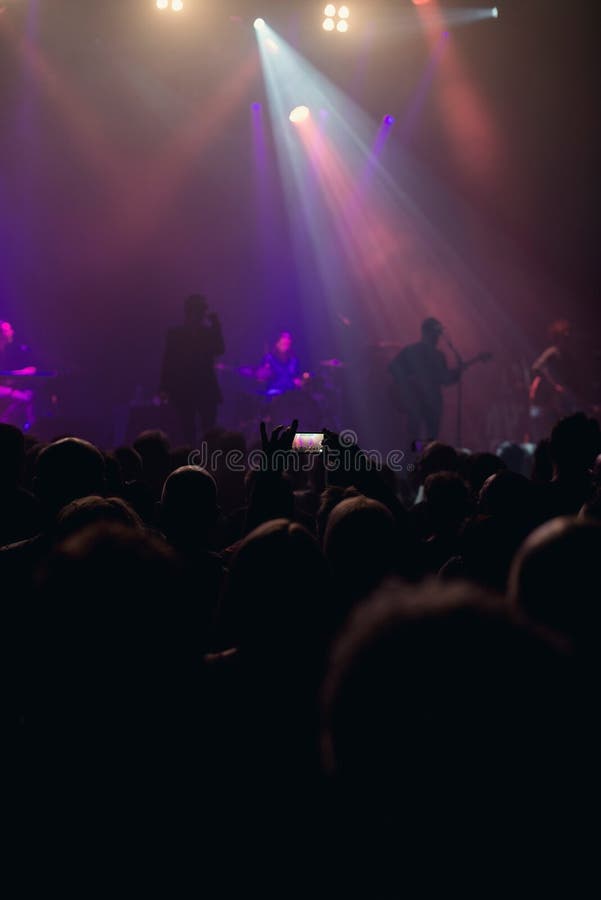 Concert Goer Taking Photos with Mobile of Rock Band. Stock Photo ...