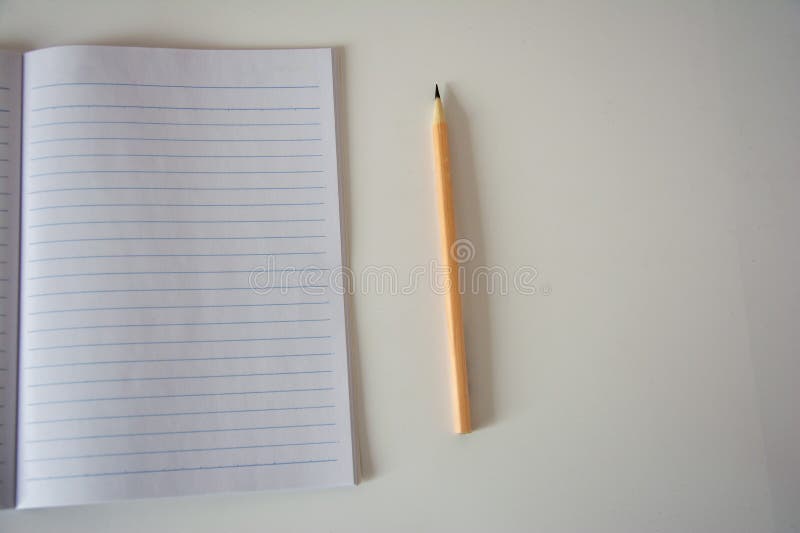 A Concise Scene of a White Notebook and a Yellow Pencil Stock Photo ...