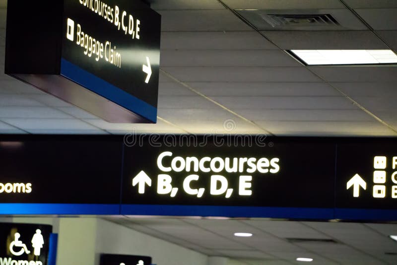 Concourse Sign and Directional Arrows at an Airport Stock Photo - Image ...