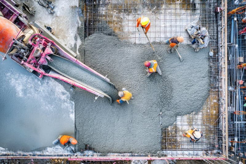 Aerial View of Construction Workers Pouring Concrete, Highlighting the ...