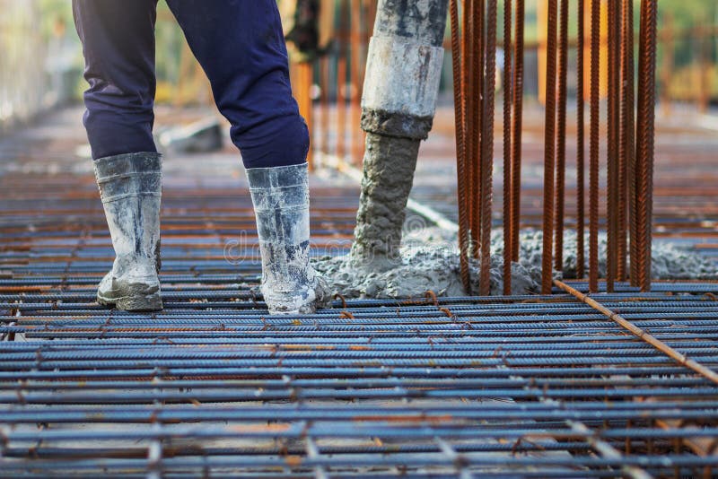 Concrete is Being Poured into a Steel Reinforcement Frame at the ...