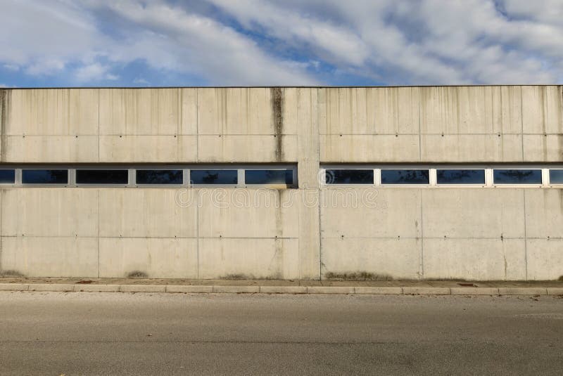 Concrete Block Wall with a Row of Small Windows in the Upper Side ...