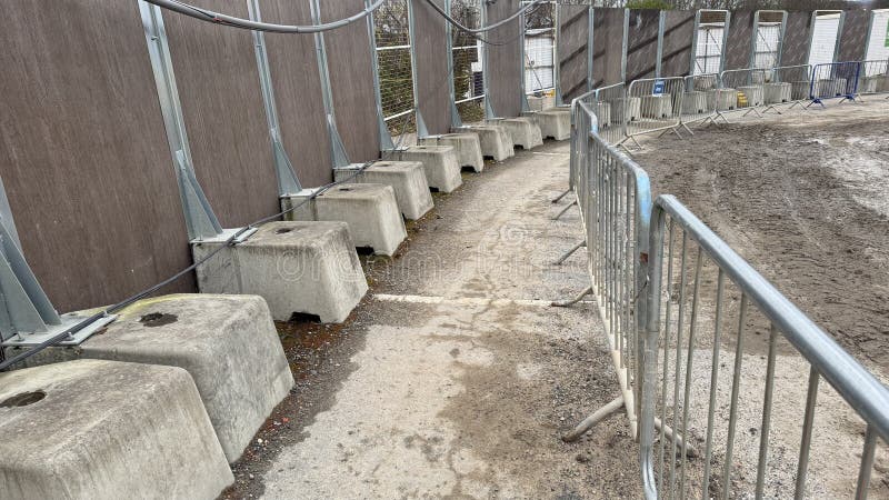 Concrete Blocks Supporting Temporary Wall and Metal Barricade at ...