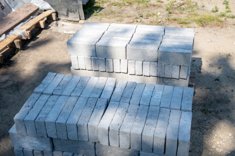 Concrete Bricks Neatly Stacked on Wooden Pallets, Sunlight Creates ...