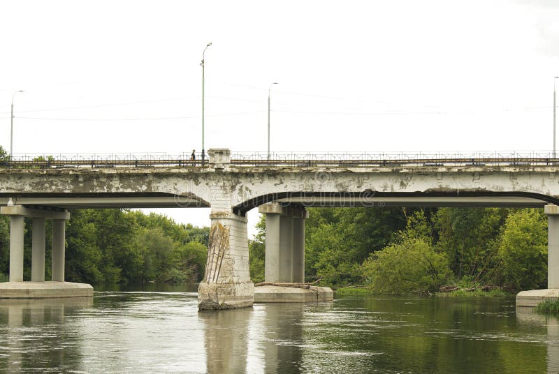 A Concrete Bridge Spanning a River with Trees Lining the Banks. Stock ...