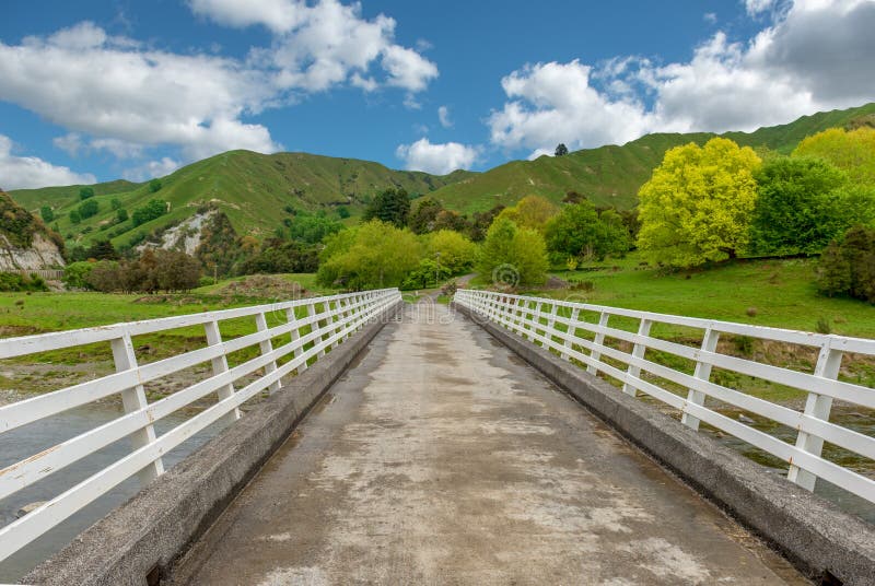 A Concrete Bridge with White Railings Spanning a River Stock Image ...