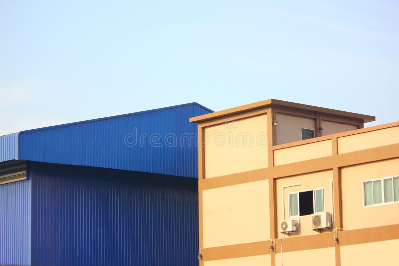Concrete Building in Front of Corrugated Metal Sheet Ware House ...