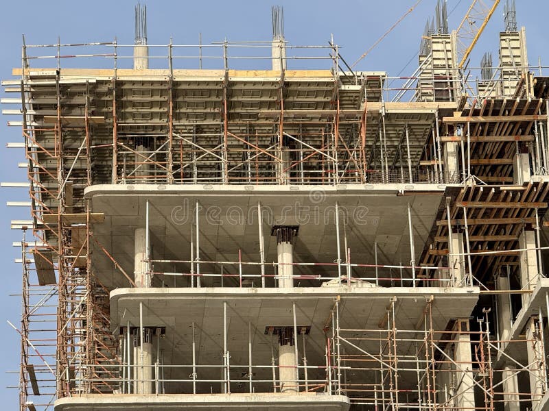 Concrete Building Under Construction with Dense Metal Scaffolding ...