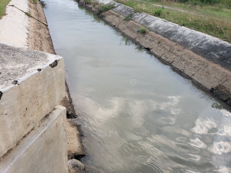Concrete Canal with Cloudy Water Reflections Stock Image - Image of ...