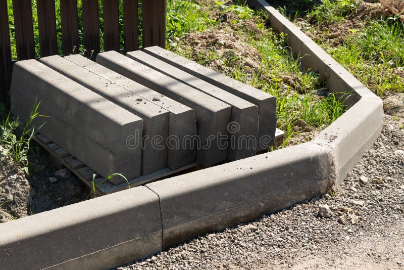 Concrete Curb Construction with Wooden Formwork. Wood Board is Secured ...