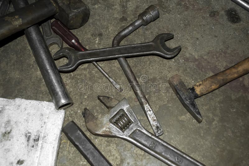 On Concrete is a Dirty Working Tool. Scattered Tools. There is a Wrench ...