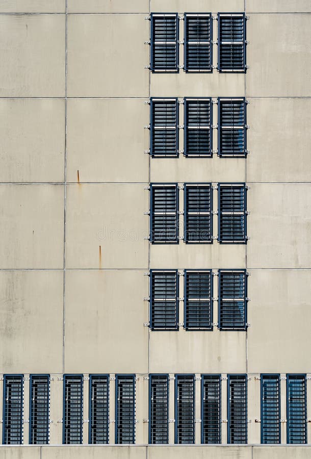 The Concrete Facade of a Prison. the Windows are Fitted with Bars so ...