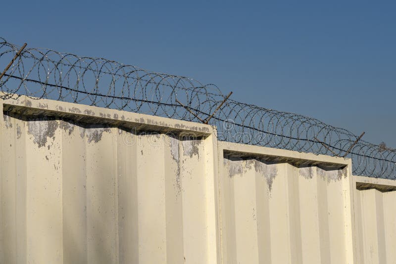 Concrete Fence with Barbed Wire on Top. Stock Photo - Image of ...