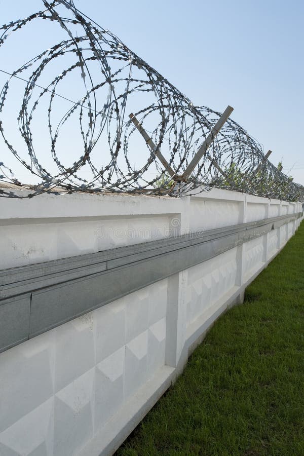 Concrete Fence with Razor Wire Stock Photo - Image of fence, boundary ...