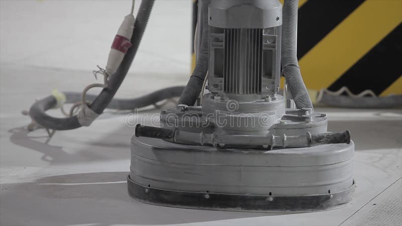 Floor Grinding at a Construction Site. a Builder Works with an ...