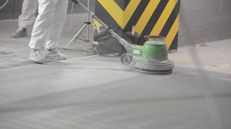Floor Grinding at a Construction Site. a Builder Works with an ...