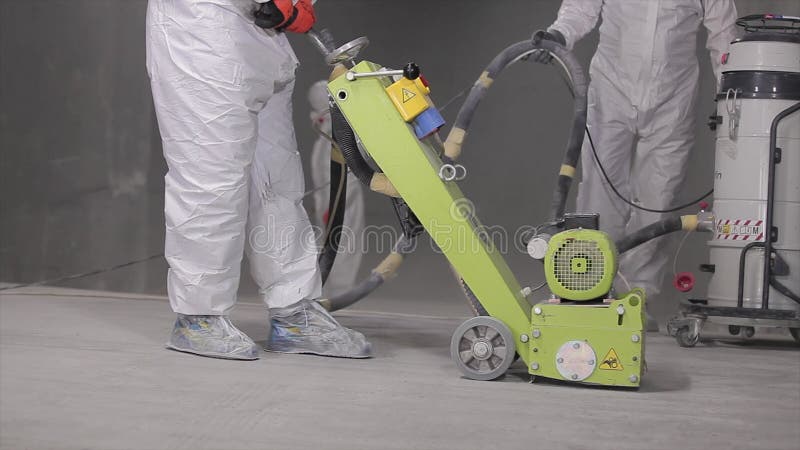 Floor Grinding at a Construction Site. a Builder Works with an ...