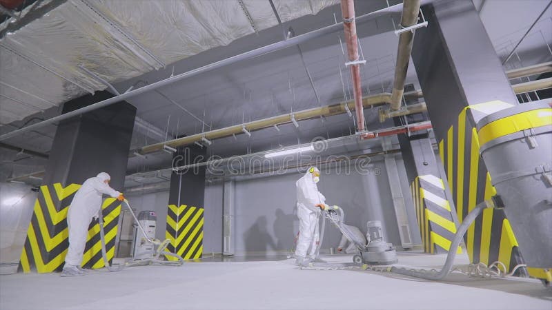 Concrete Floor Processing during Construction. Grinding a Concrete ...