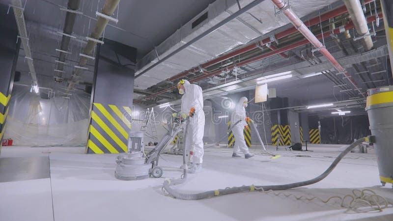 Concrete Floor Processing during Construction. Grinding a Concrete ...