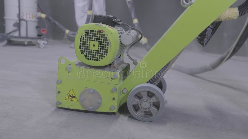 Concrete Floor Processing during Construction. Grinding a Concrete ...