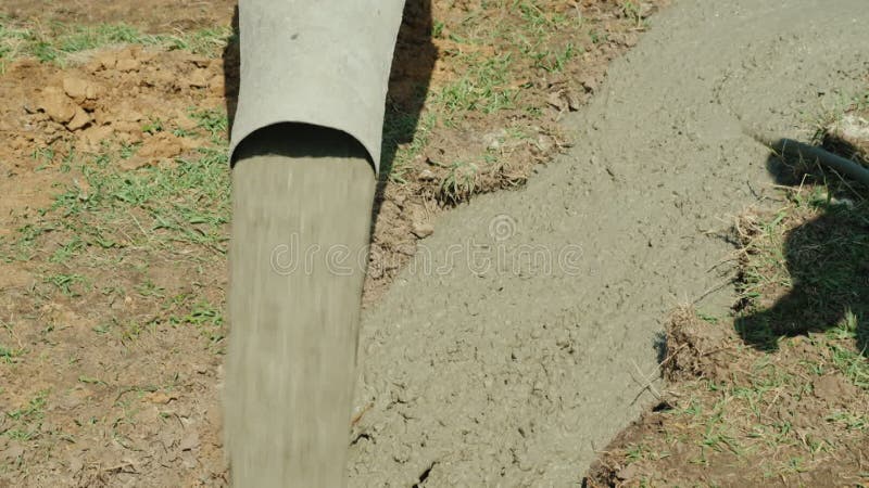 Concrete Begins To Flow from a Large Pipe - it Fills the Foundation of ...