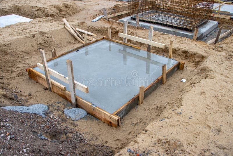 Concrete Foundations for the Columns of a Factory Building are Poured ...