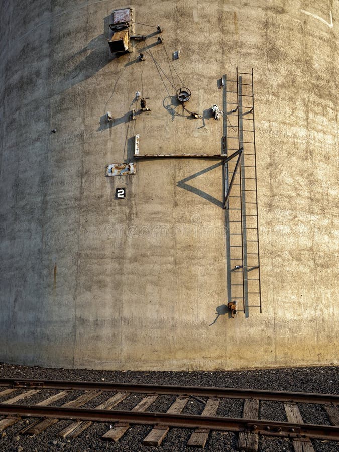A Concrete Grain Storage Bin with a Ladder and Platform To Access the ...